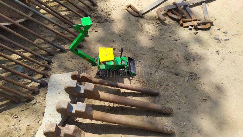 Iron Tools and a Small Iron Excavator Stock Photo - Image of wood ...