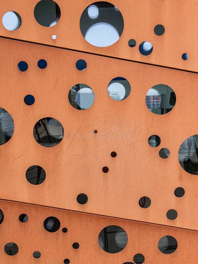 Iron Wall with Circular Cutouts in Front of the Building Stock Image ...