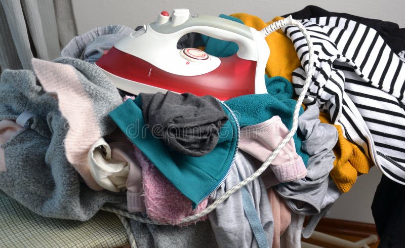 Pile of Unfolded Clothes on the Bed Ready for Laundry Stock Photo ...