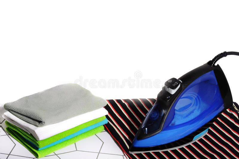 On the Ironing Board is a Blue Iron and Neatly Folded Ironed Stack of ...