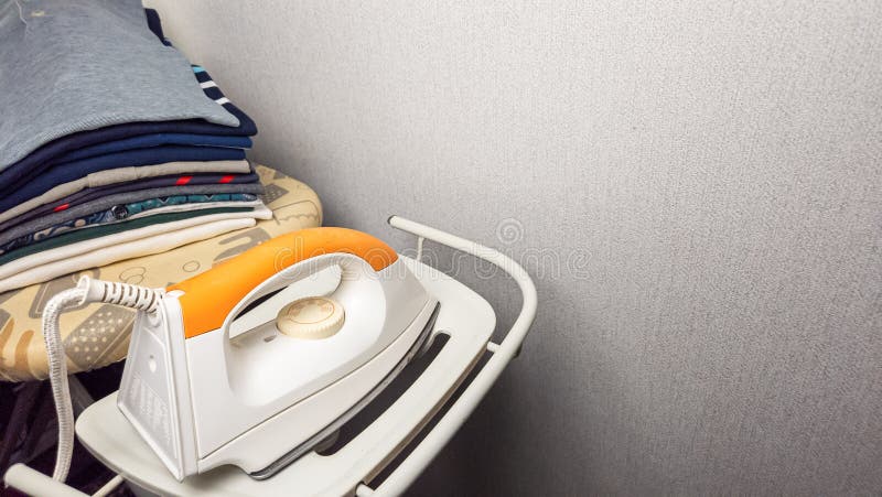 Ironing Board with Iron and Folded Clothes Ready for Use Stock Image ...