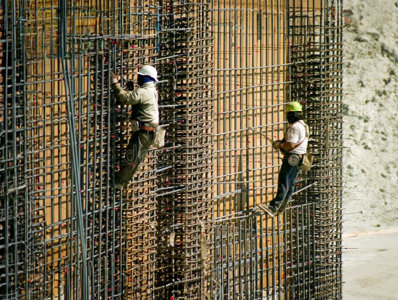 Ironworkers Attached To Rebar on a Vertical Wall at a Construction Site ...