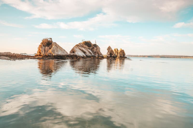 Irregular Shaped Rocks in a Quiet Ocean Bay Stock Photo - Image of ...