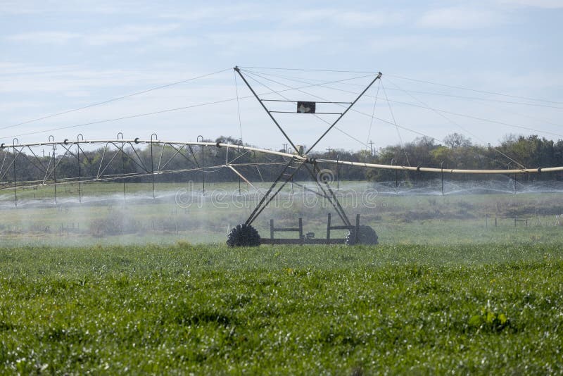 An Irrigation Pivot Watering a Field of Crops Stock Photo - Image of ...