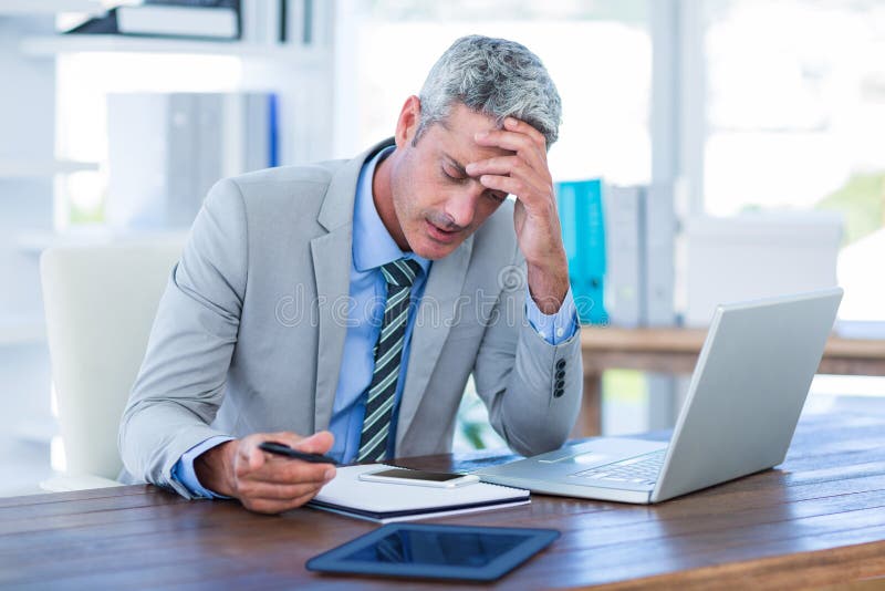 Irritated Businessman Trying To Work Stock Image - Image of irritated ...