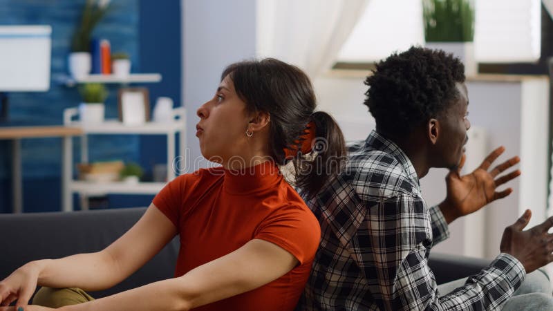 Irritated Interracial Couple Getting into Argument on Sofa Stock Photo ...