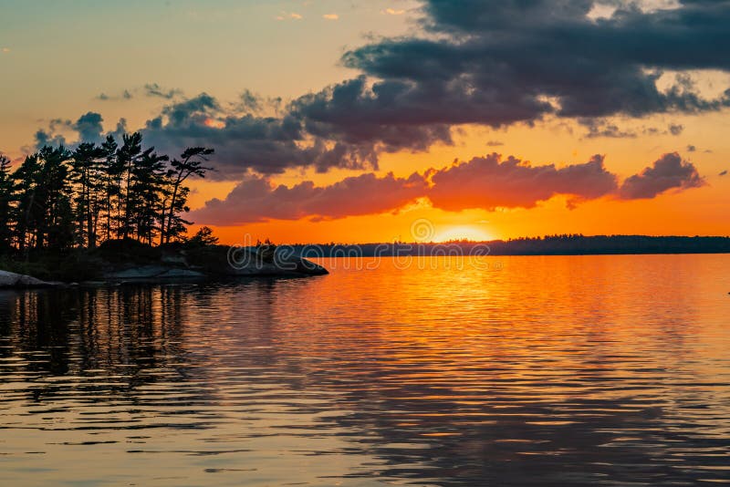 Rainy lake at sunset stock image. Image of reflections - 81162425
