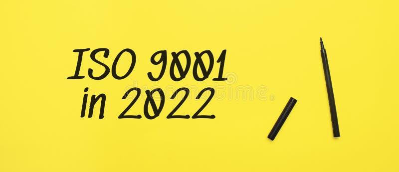 ISO 9001 in 2022 Sign with Black Marker on a Yellow Background. with ...