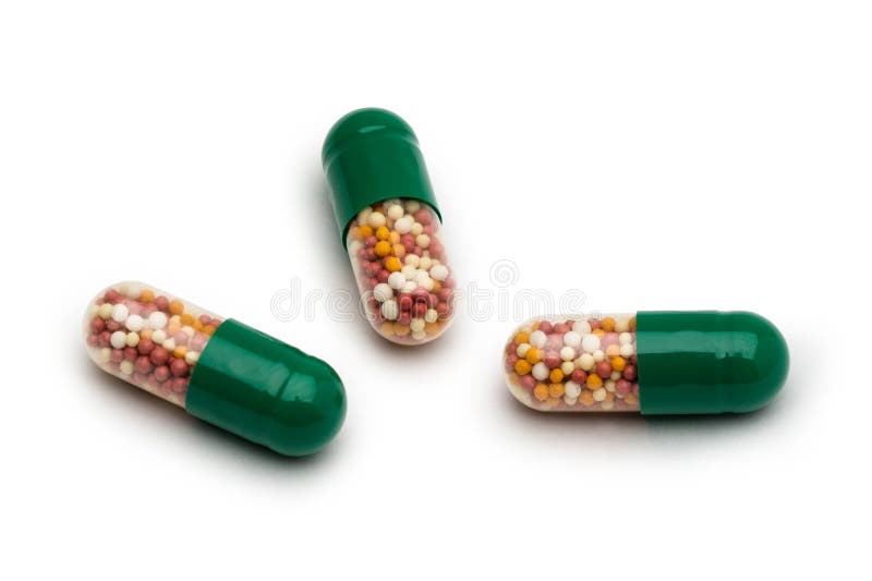 Isolate. Three Separate Green Capsules with Medicine on a White ...