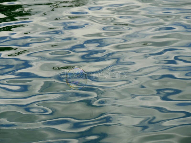 Isolated Floating Soap Bubble Landing in Water, Simple Background Stock ...