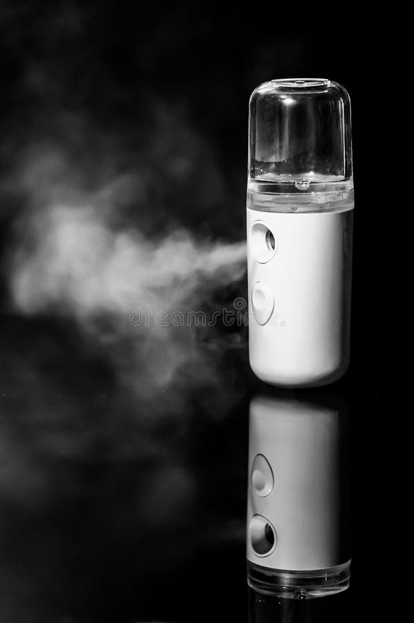 Isolated Grayscale Shot of a Spray Bottle with Steam Emanating from the ...