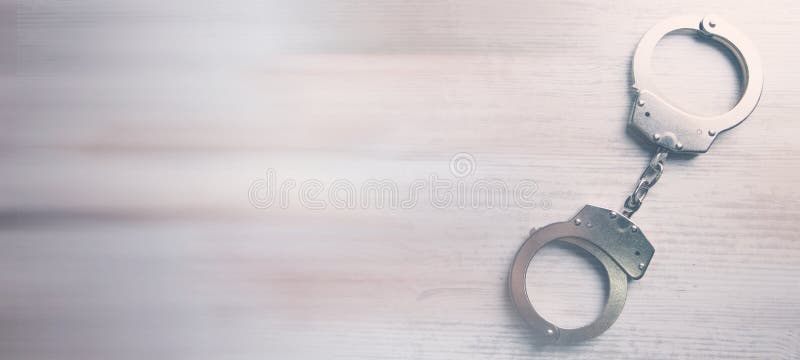 Isolated Handcuffs, Banner and Copy Space on a Wooden Background Stock ...