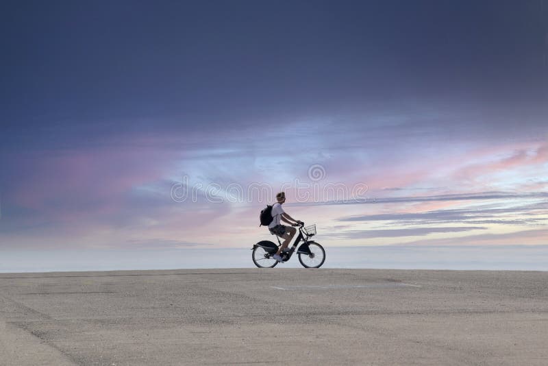 Isolated Man Riding a Bicycle Against a Sunset Sky. Negative Space ...