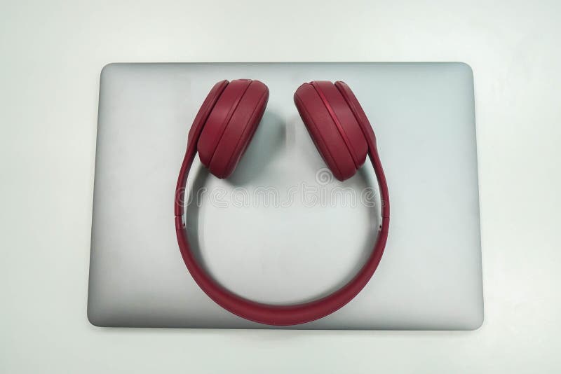 Isolated Notebook Cute Pink Wireless Headphone on Notebook Computer in ...