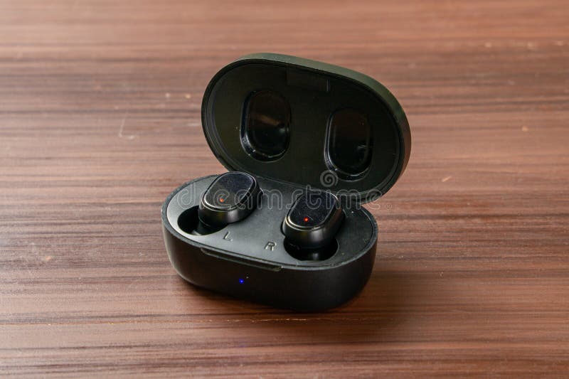 An Isolated Pair of Black TWS or True Wireless Stereo Earbuds Placed on ...