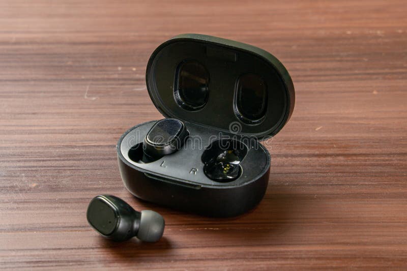 An Isolated Pair of Black TWS or True Wireless Stereo Earbuds Placed on ...