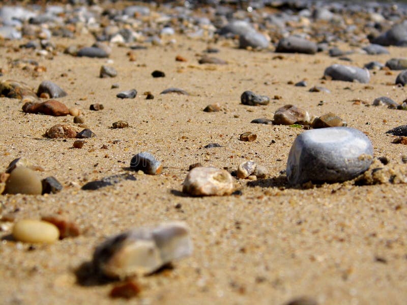 An Arty View of Beach Pebbles on a Sandy Beach Stock Photo - Image of ...