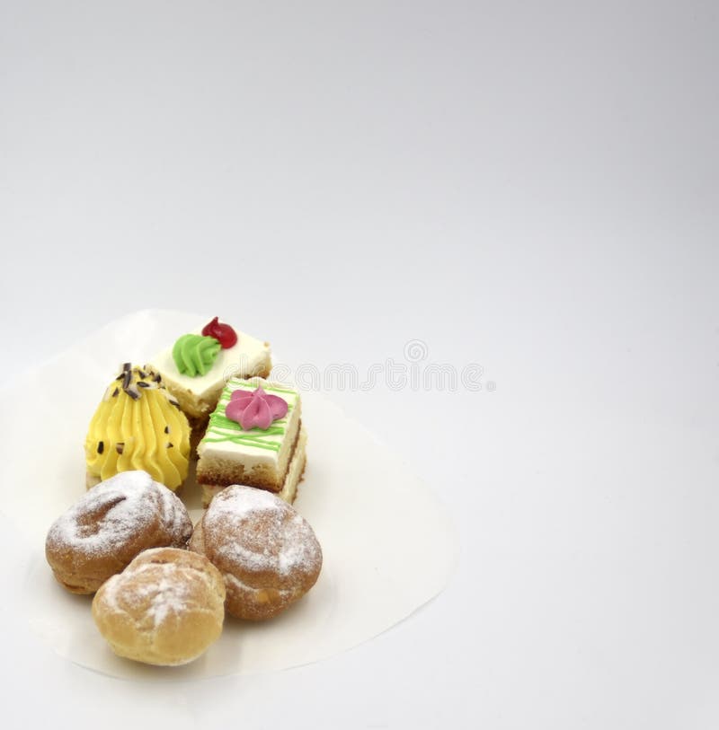 Isolated Mini Cakes and Puffs with Cream and Sugar Powder Stock Photo ...