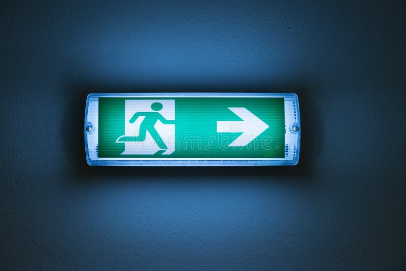 Isolated Shot of an Emergency Exit Sign on the Blue Wall Stock Photo ...