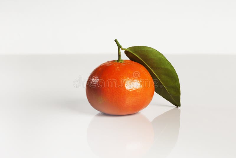 Isolated Single Orange Mandarin Fruit on Reflective White Surface Stock ...