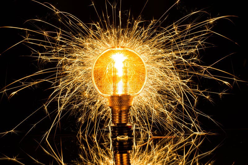 Isolated Sparkling Exploding Electric Light Bulb on Black Background ... Isolated Sparkling Exploding Electric Light Bulb on Black Background ...