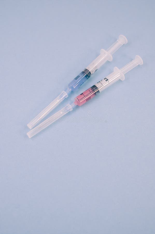 Isolated Sterilized Injection Syringes on a Blue Background Stock Photo ...