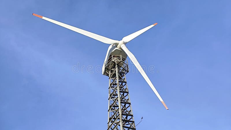 Isolated Wind Turbine in Blue Sky Stock Photo - Image of renewable ...