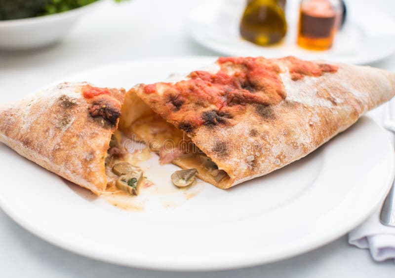 Italian Bread Calzone in Restaurant Stock Image - Image of basil ...