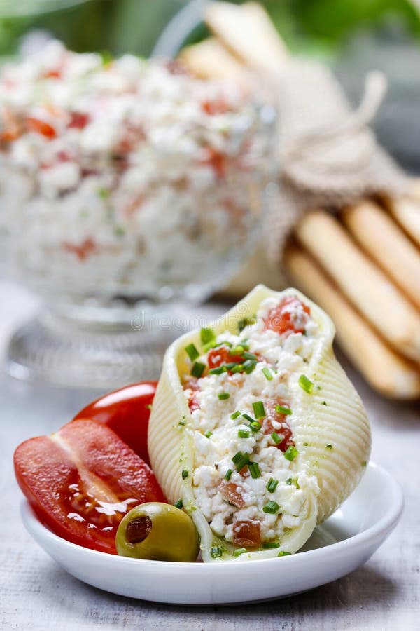Italian Cuisine: Stuffed Pasta Shells and Stack of Breadsticks. Stock ...