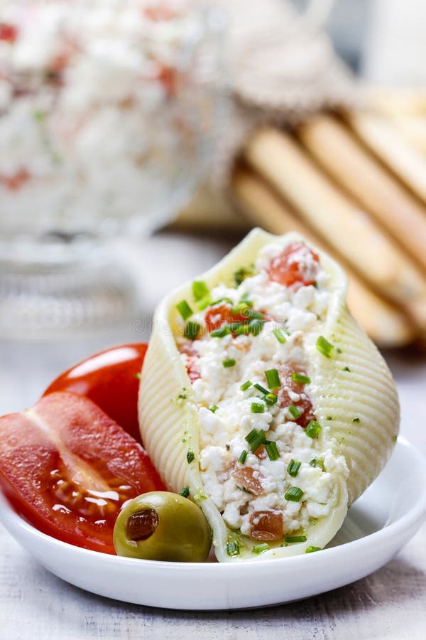 Italian Cuisine: Stuffed Pasta Shells and Stack of Breadsticks. Stock ...