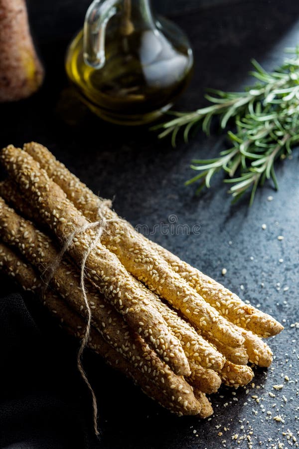 Italian Grissini Bread Sticks with Sesame Seeds on Black Table Stock ...