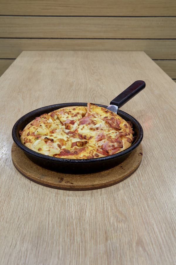 Italian Pizza in Chopping Board on a Wooden Table Stock Photo - Image ...