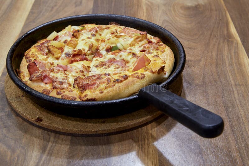 Italian Pizza in Chopping Board on a Wooden Table Stock Image - Image ...