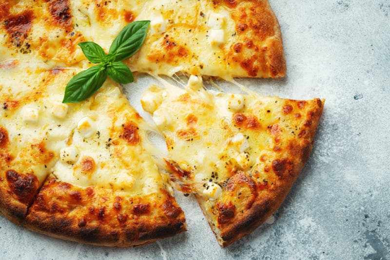 Italian Pizza Four Cheeses with Stretching Cheese and Basil on a Light ...
