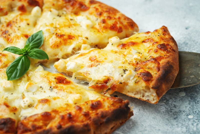 Italian Pizza Four Cheeses with Stretching Cheese and Basil on a Light ...