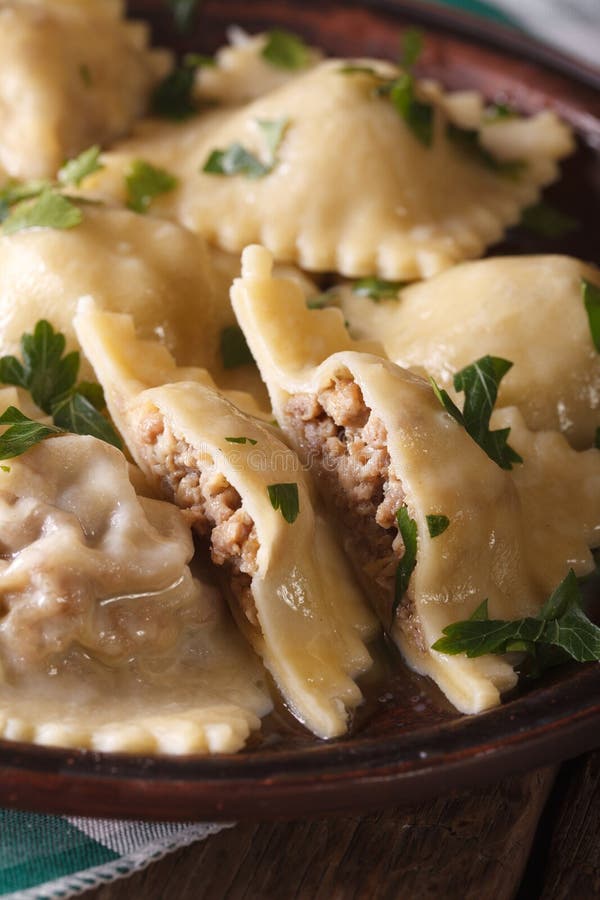 Italian Ravioli with Meat Closeup on a Brown Plate. Vertical Stock ...