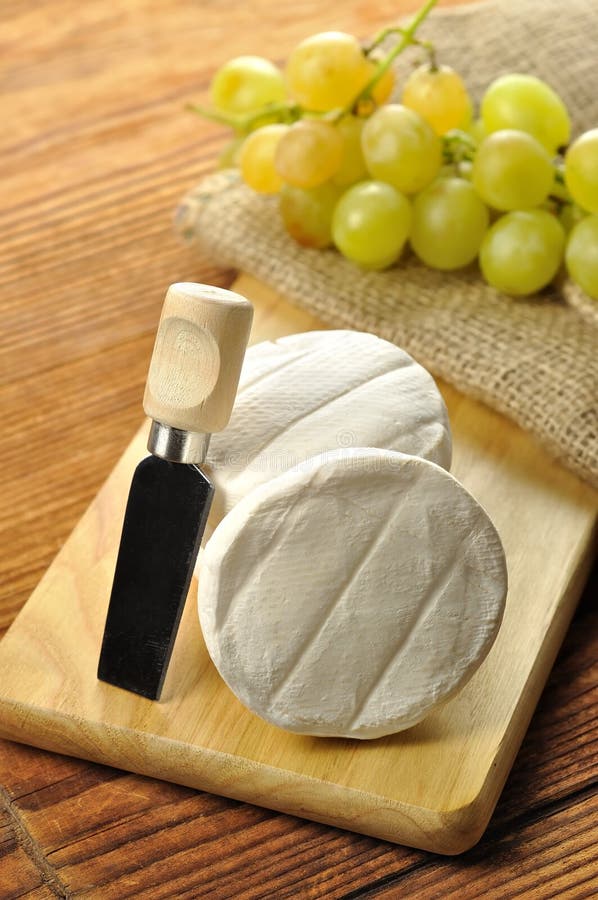 Italian Tomino Cheese on a Wooden Chopping Board Stock Image - Image of ...