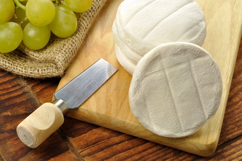 Italian Tomino Cheese on a Wooden Chopping Board Stock Image - Image of ...