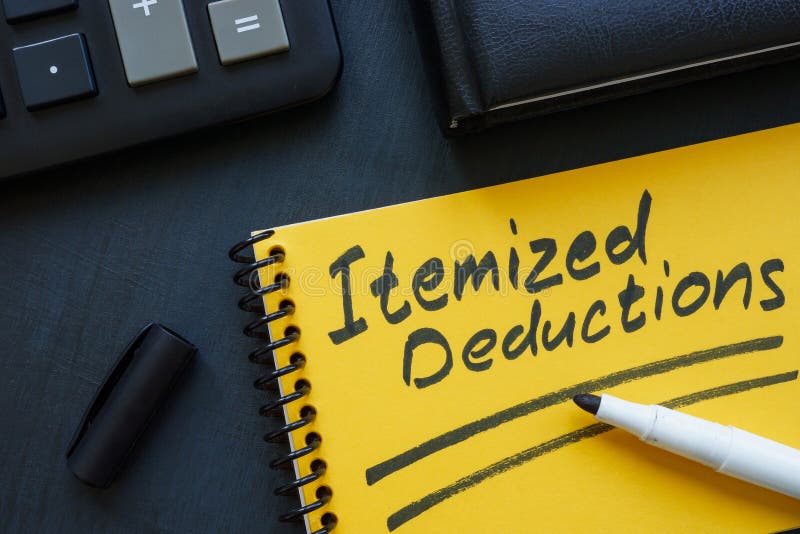 Itemized Deductions Handwritten Note in a Yellow Notepad. Stock Photo ...