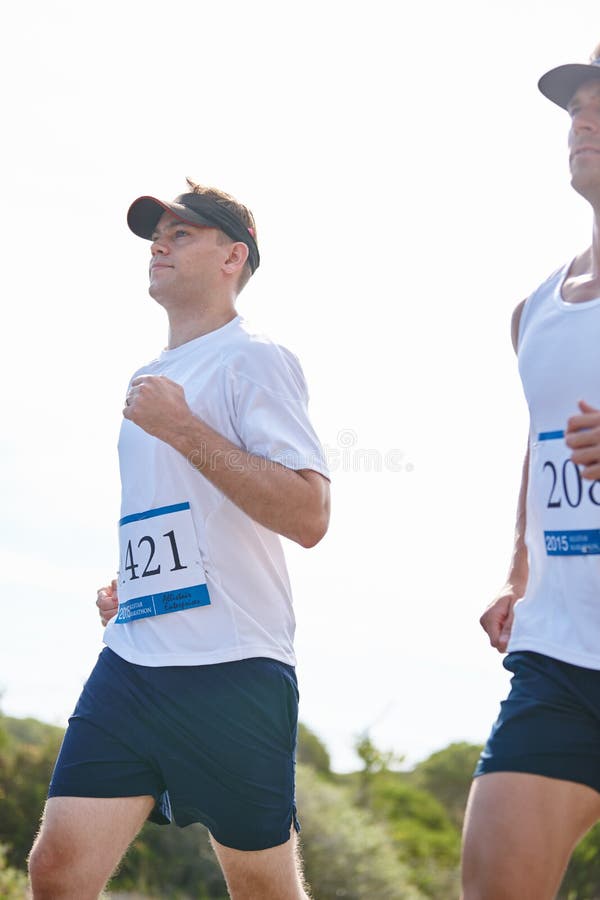 Its All about Endurance. Young Men Running a Marathon. Stock Photo ...