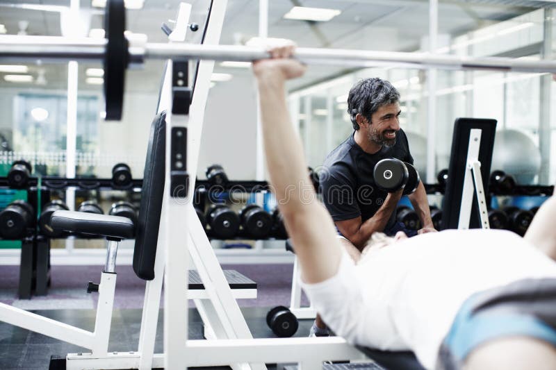 Its All Smiles in the Gym. Two Men Lifting Weights in the Gym. Stock ...
