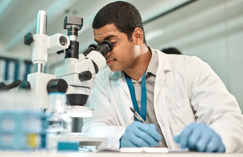 Its Been a Day Full of Tests. a Young Scientist Writing Notes while ...