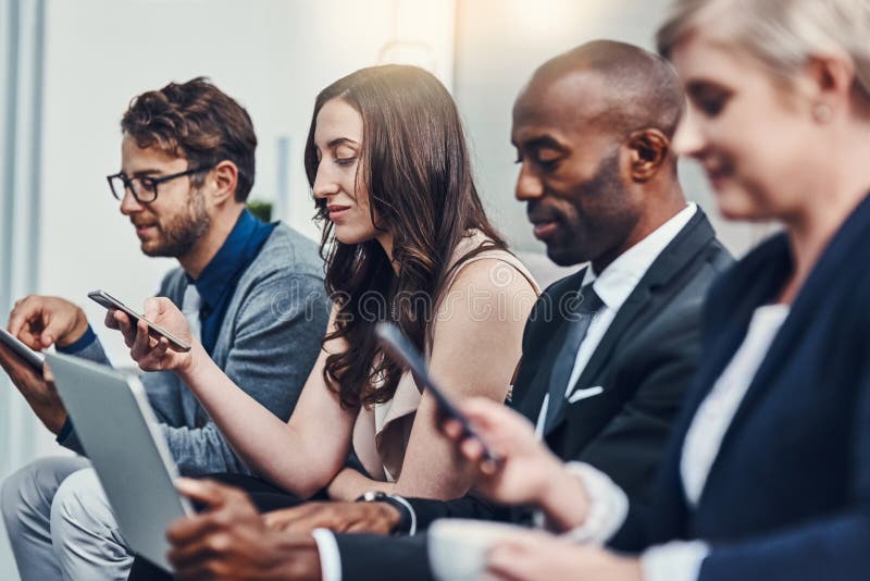 Its a Busy Office. a Group of Businesspeople Using Various Digital ...