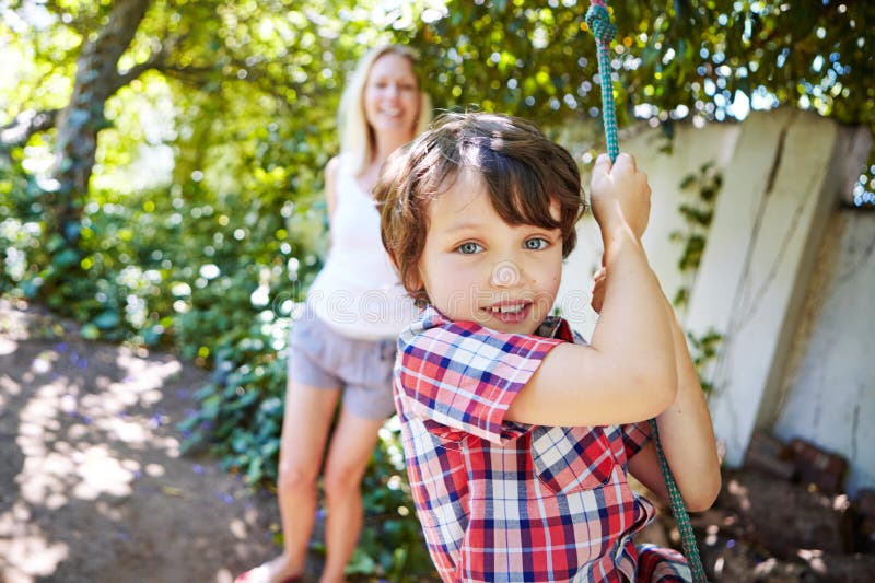 Its Fun Being a Kid. a Young Boy Swinging in the Yard. Stock Image ...