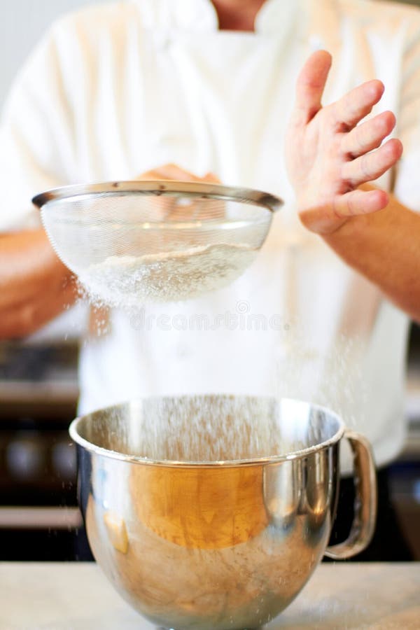 Its an Important Step. a Baker Sifting Flour into a Metal Bowl. Stock ...