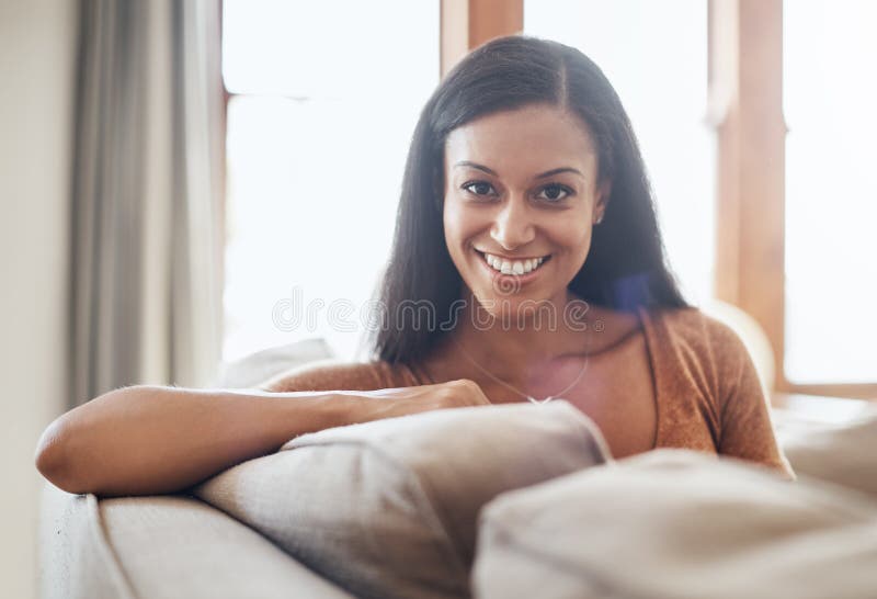 Time To Unwind A Beautiful Woman Relaxing On A Chair At Home Stock