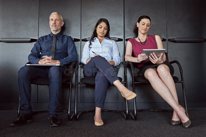 Its Interview Time. Full Length Sshot of Three People Sitting in Line ...