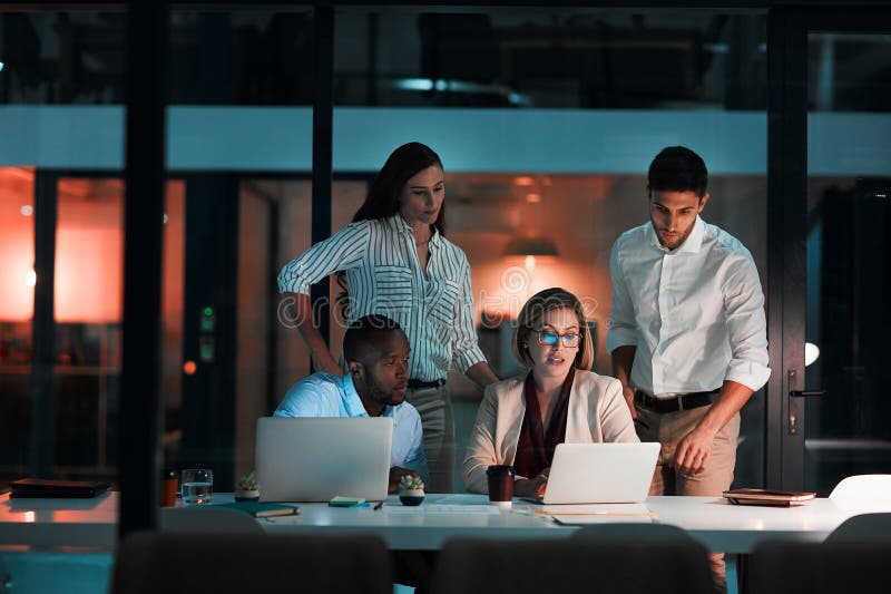 Its Not Done until Its Done. Colleagues Using a Laptop Together during ...