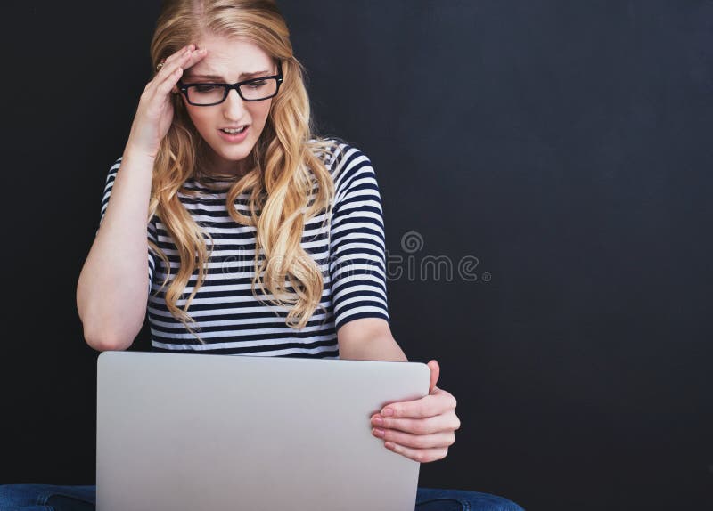 Its Not always that Simple. Studio Shot of a Young Woman Using a Laptop ...