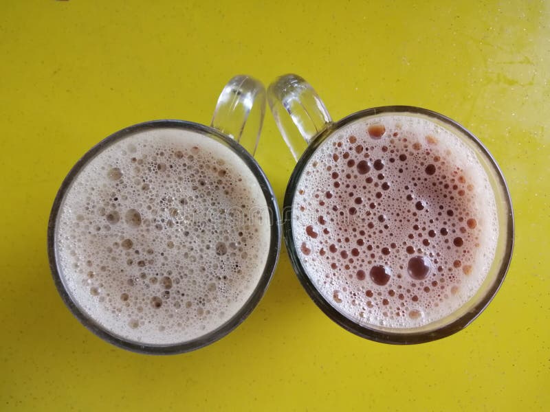 Its Take Two To Tango. 2 Cups of Drink on Yellow Table Stock Photo ...